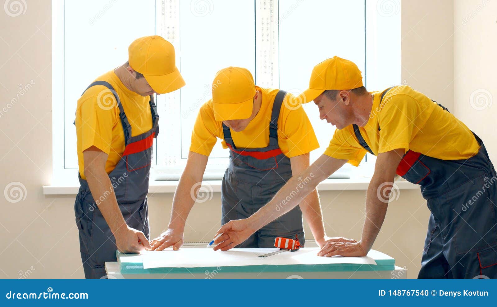 Group of Builders Looking at the Construction Project. Stock Photo ...