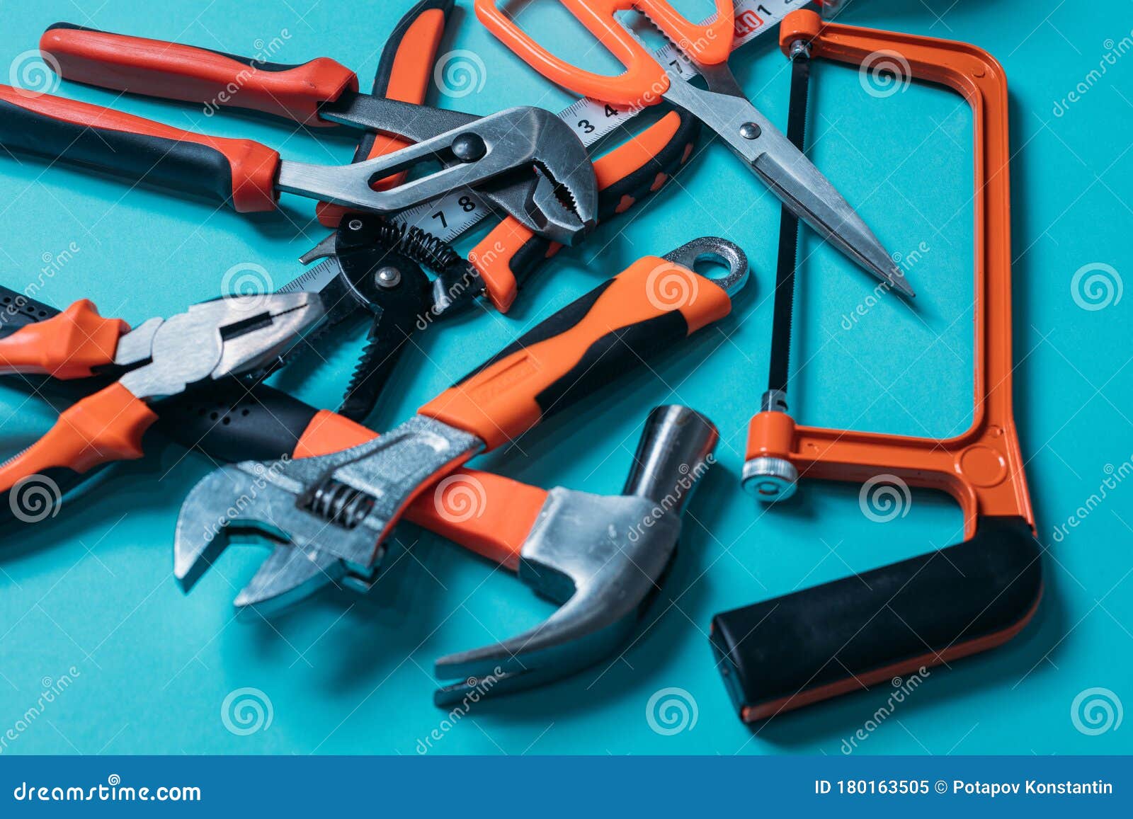 Group Bunch of Tools with Orange Handles on a Blue Background Close ...