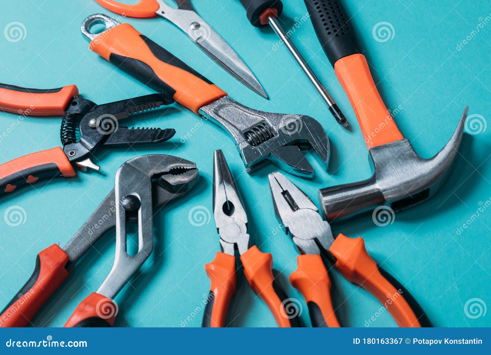 Group Bunch of Tools with Orange Handles on a Blue Background Close ...