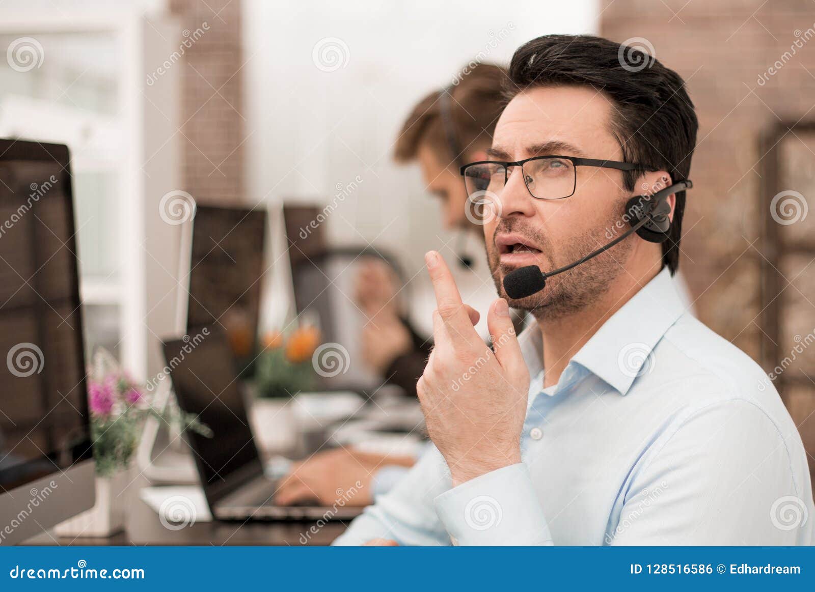 Group of Business Colleagues with Headsets Using Computers at Office ...