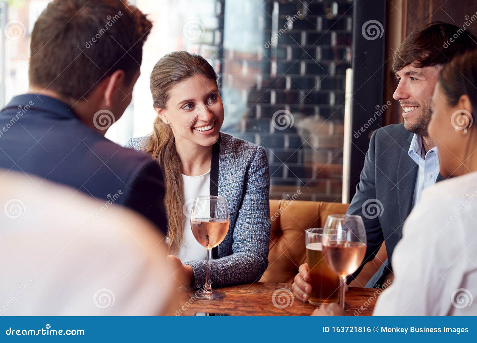 Group of Business Colleagues Meeting for Drinks and Socializing in Bar ...