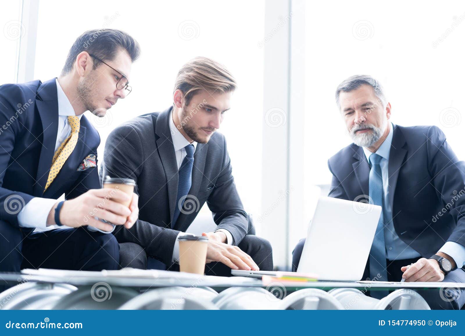 Group of Business Partners Discussing Ideas and Planning Work in Office ...