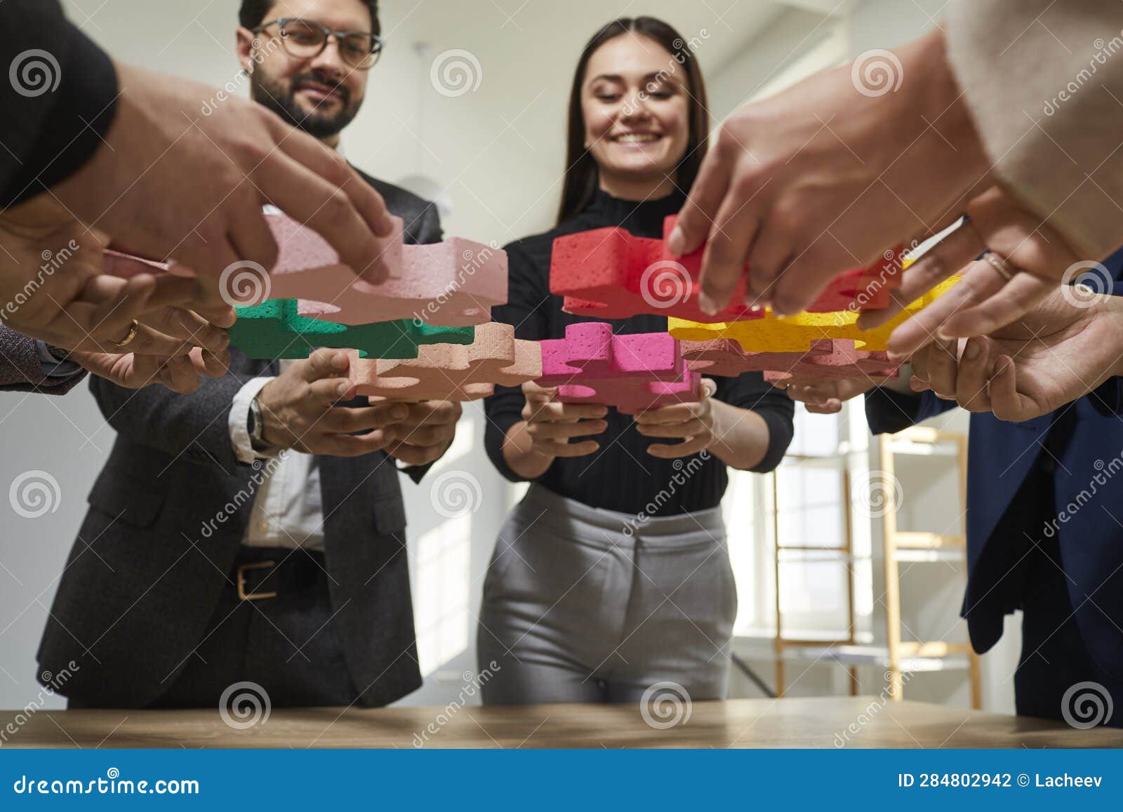 Group of Business People Assembling Jigsaw Puzzle at Office ...