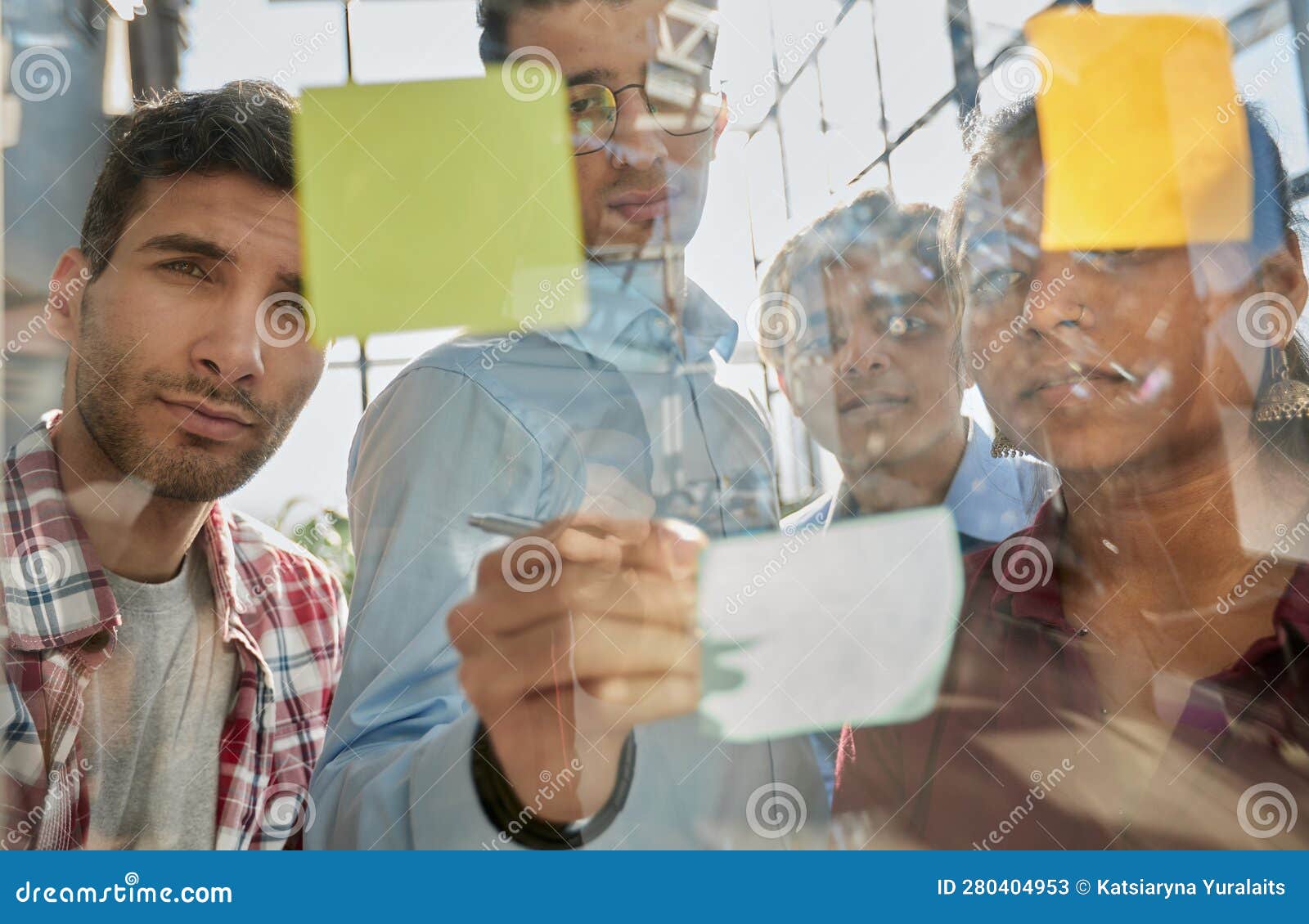 A Group Of Business People Behind A Glass Wall In The Office Sticking Notes Stock Image Image