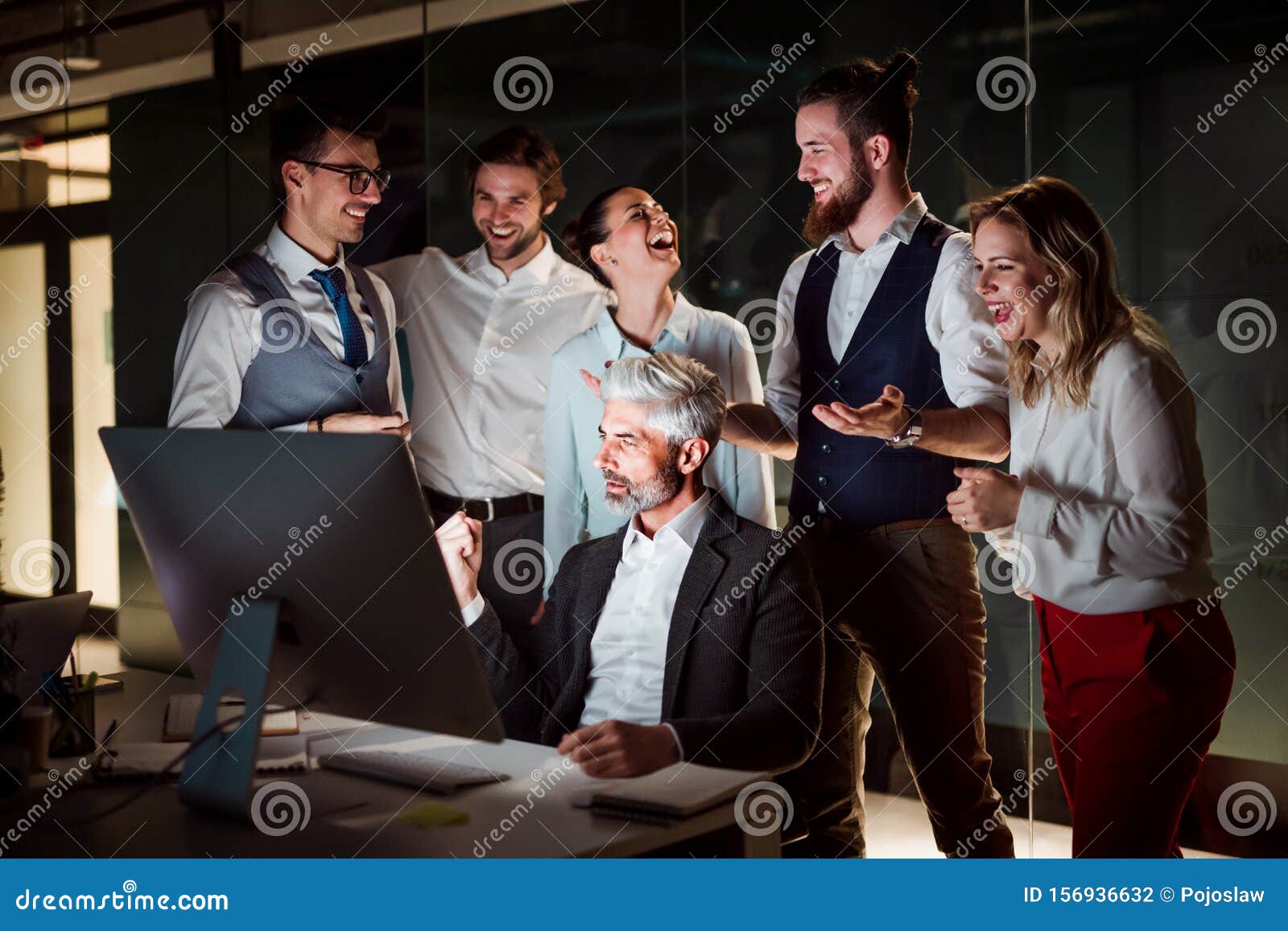 A Group of Business People with Computer in an Office, Expressing ...