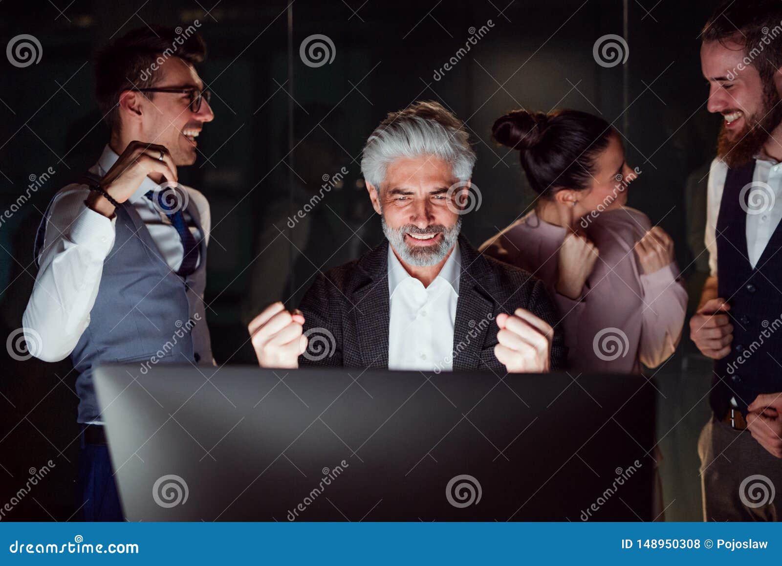 A Group of Business People with Computer in an Office, Expressing ...