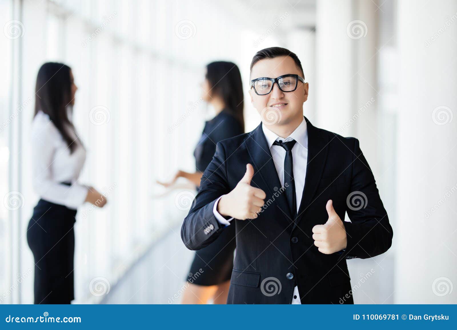 Group of Business People with Leader with Thumbs Up at Front in Office ...