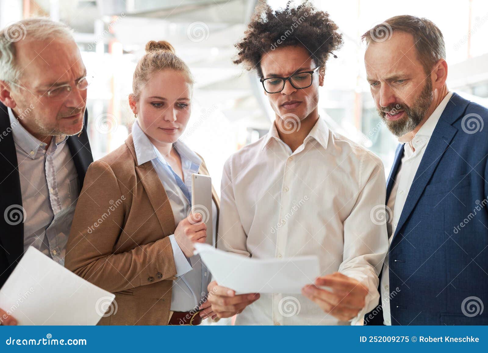 Group of Business People Looking at Contract Together Stock Image ...