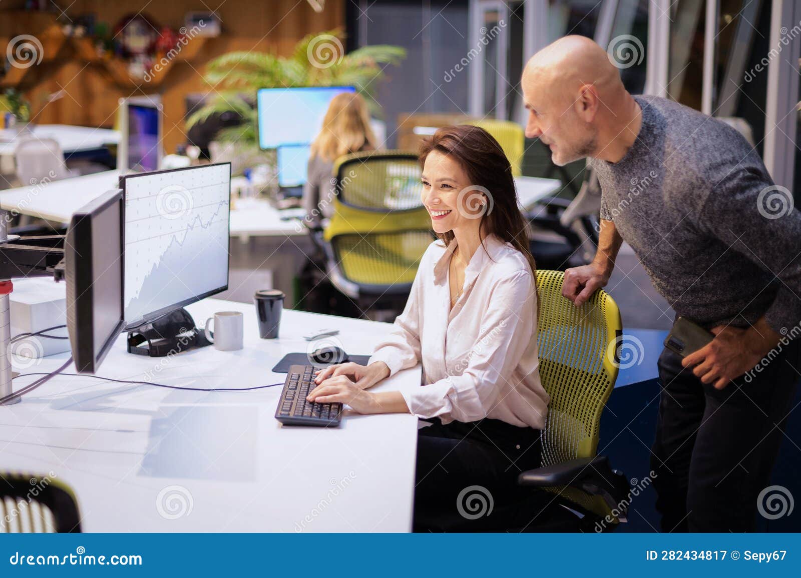 Group of Business People Sitting and Standing at Office Desk Surrounded ...