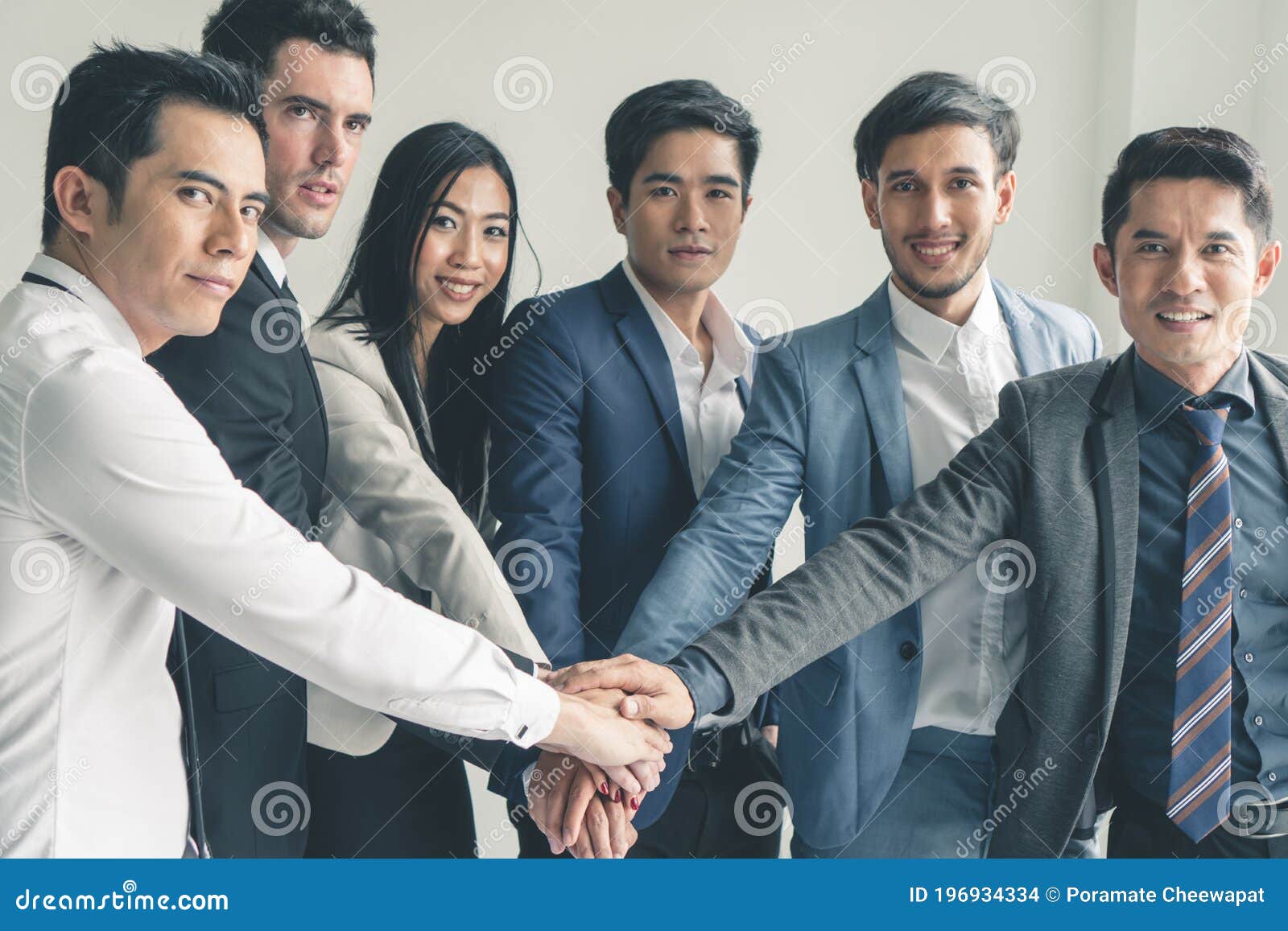 Group of Business People Stacking Hands Together Showing Power of ...