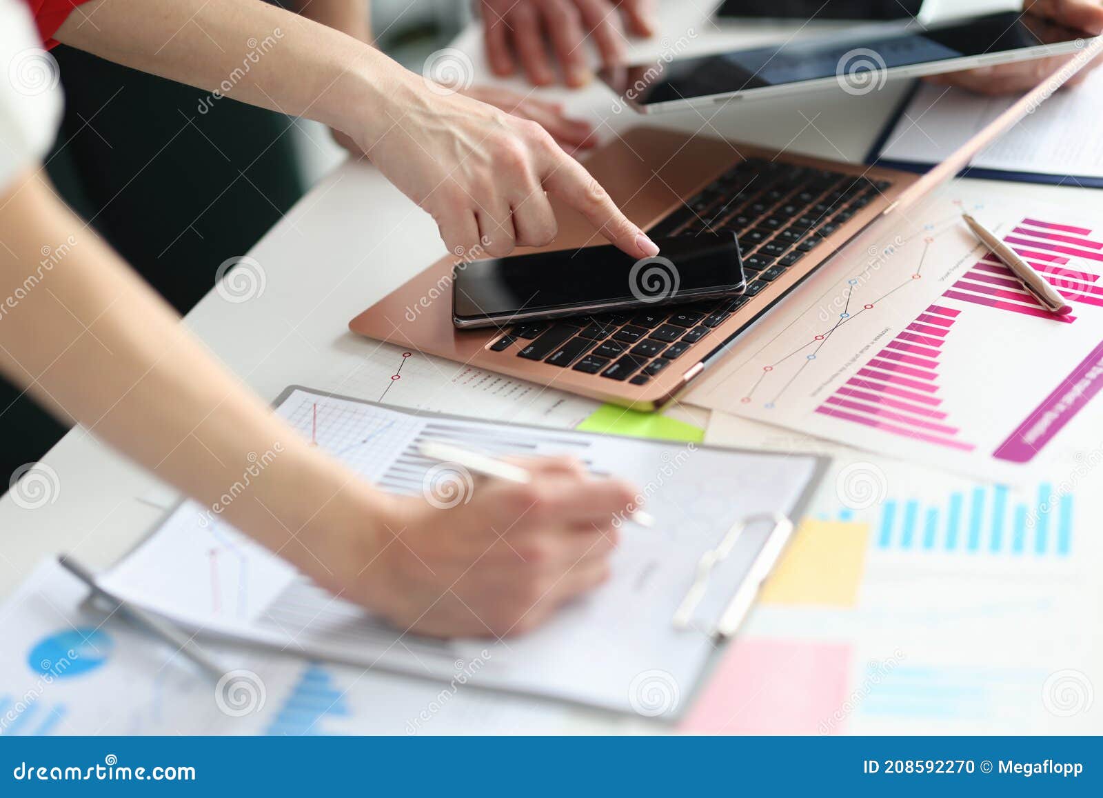 Group of Business People Studying Charts in Documents and on Gadgets ...