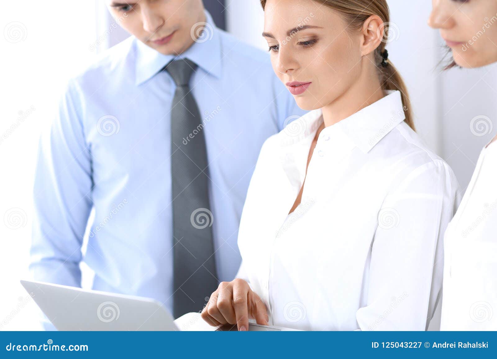 Group of Business People Using Laptop Computer while Standing in Office ...