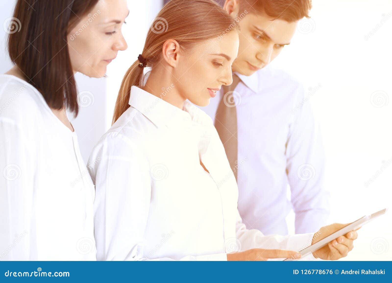 Group of Business People Using Laptop Computer while Standing in Office ...