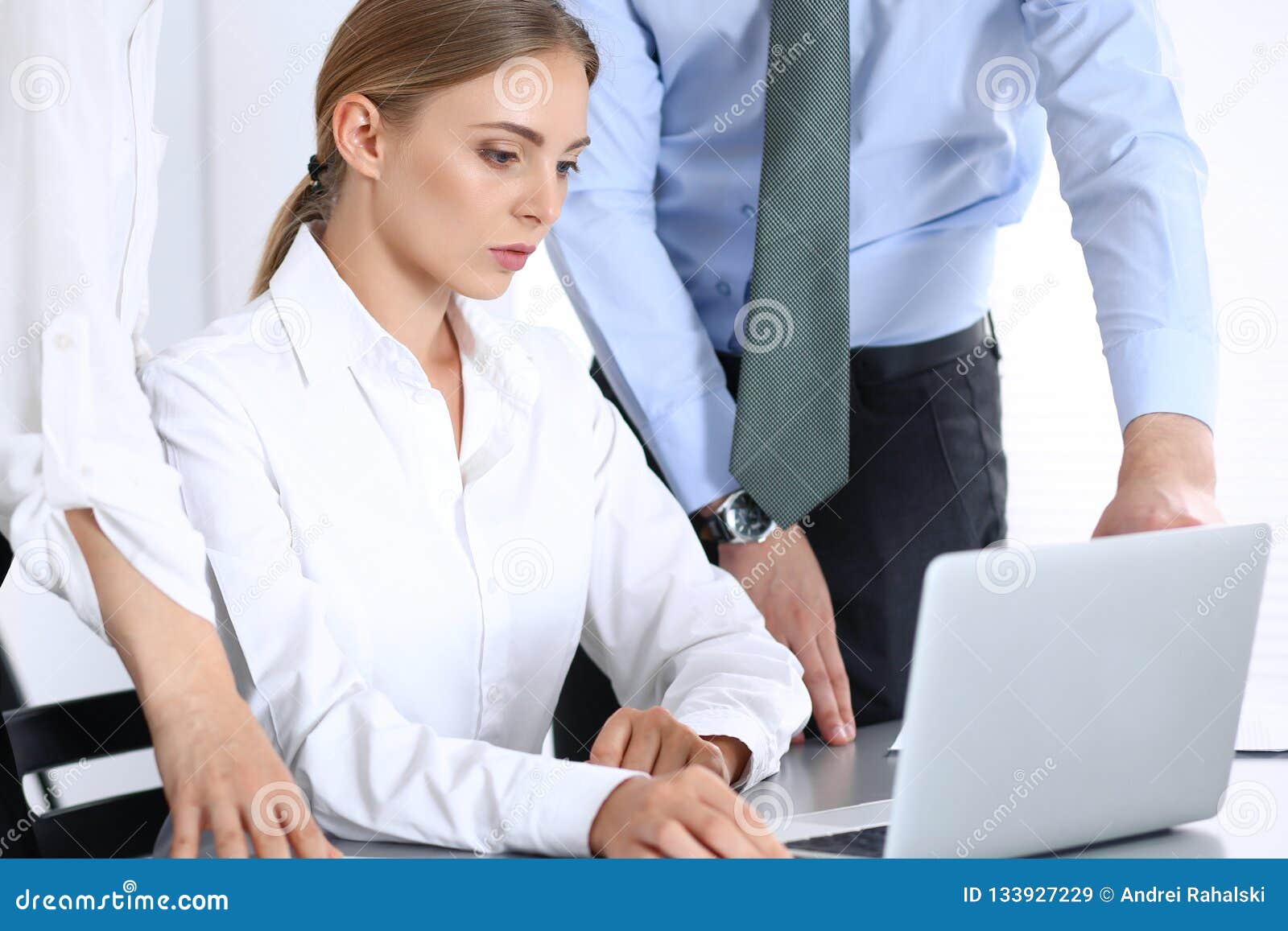 Group of Business People Using Laptop Computer while Standing in Office ...
