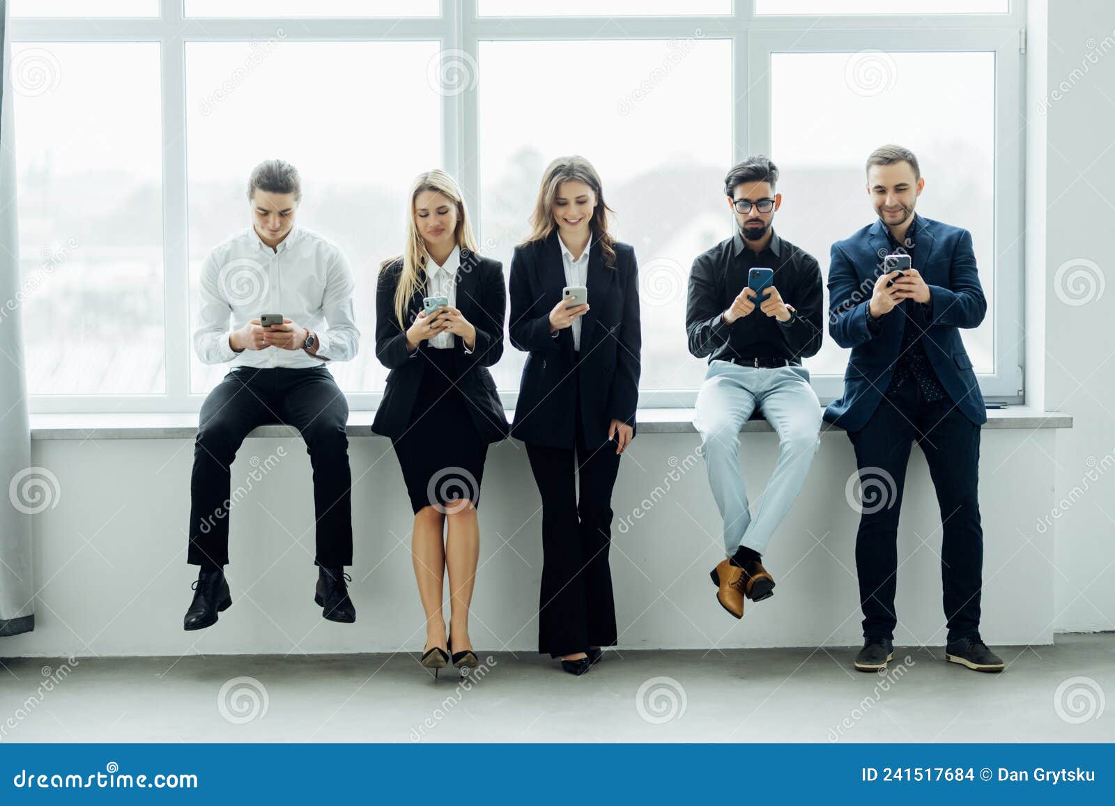 Group of Business People Using Mobile Phones and Sitting on Couch ...