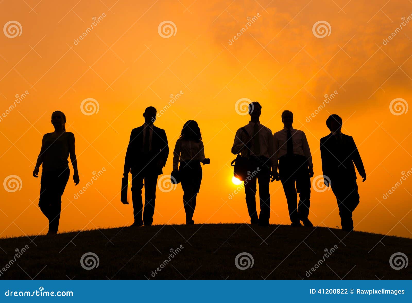 Group of Business People Walking in Back Lit Stock Photo - Image of ...