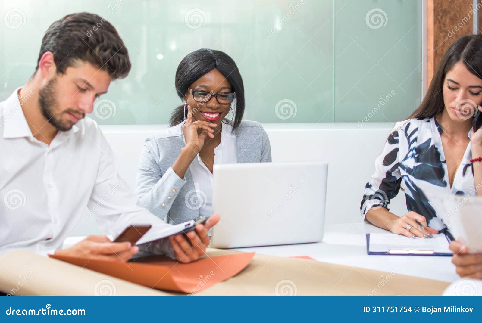 Group of Business People Working Separately on the Same Table in Office ...