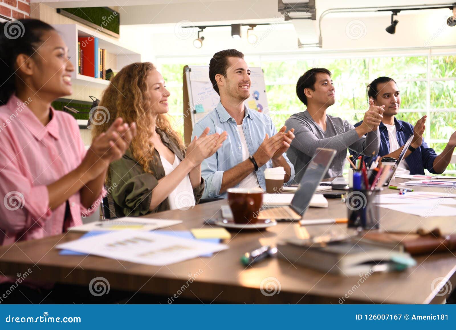 Group of Business Persons Cheering and Clapping for a Co-worker at the ...