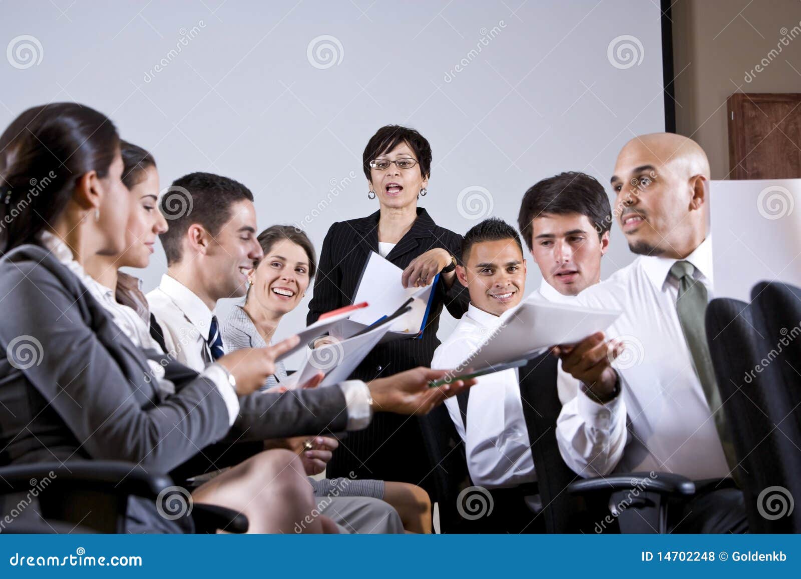Group Business Presentation Handing Out Papers Stock Photo - Image of ...