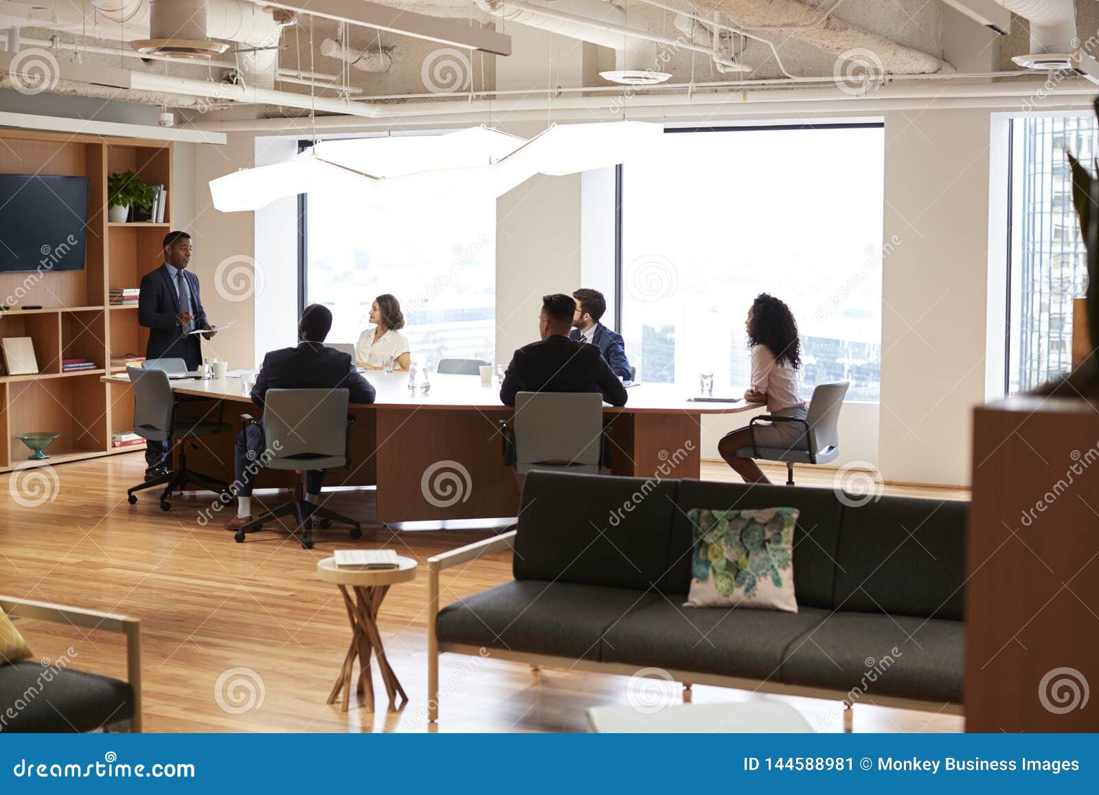 Group of Business Professionals Meeting Around Table in Modern Office ...