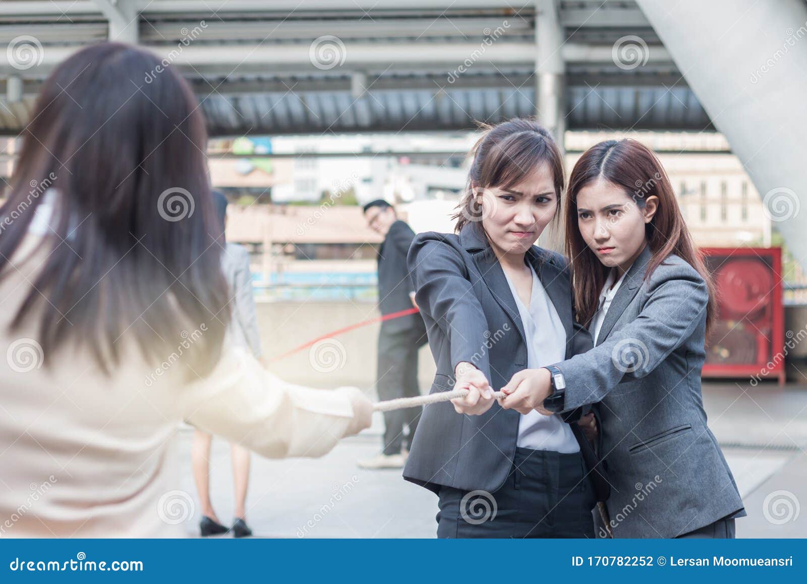 Group of Business Women Pulling a Rope Competing with Commitment To ...