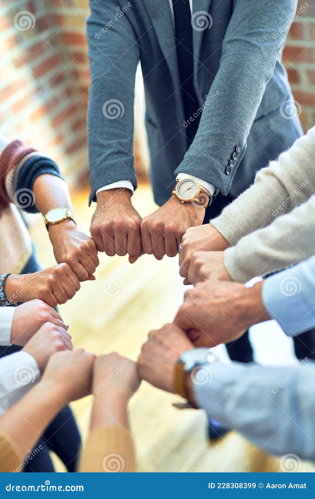 Group of Business Workers Standing Bumping Fists at the Office Stock ...