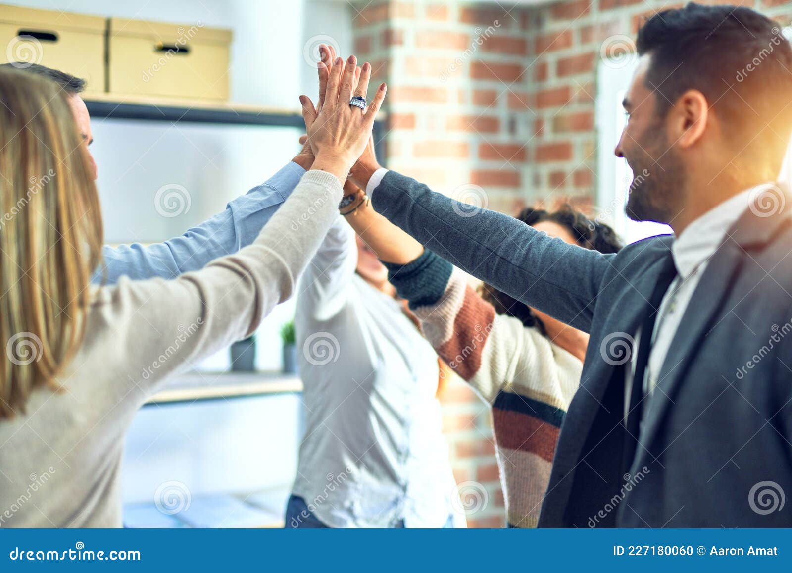 Group of Business Workers Standing with Hands Together Highing Five at ...