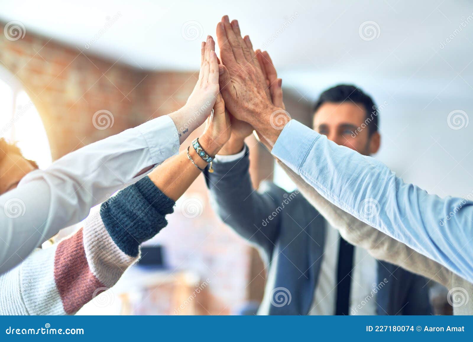 Group of Business Workers Standing with Hands Together Highing Five at ...