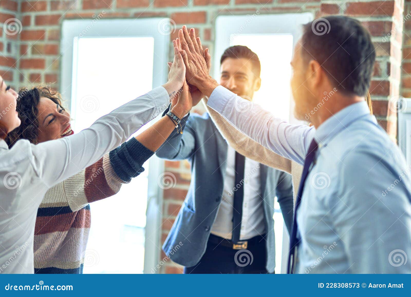 Group of Business Workers Standing with Hands Together Highing Five at ...