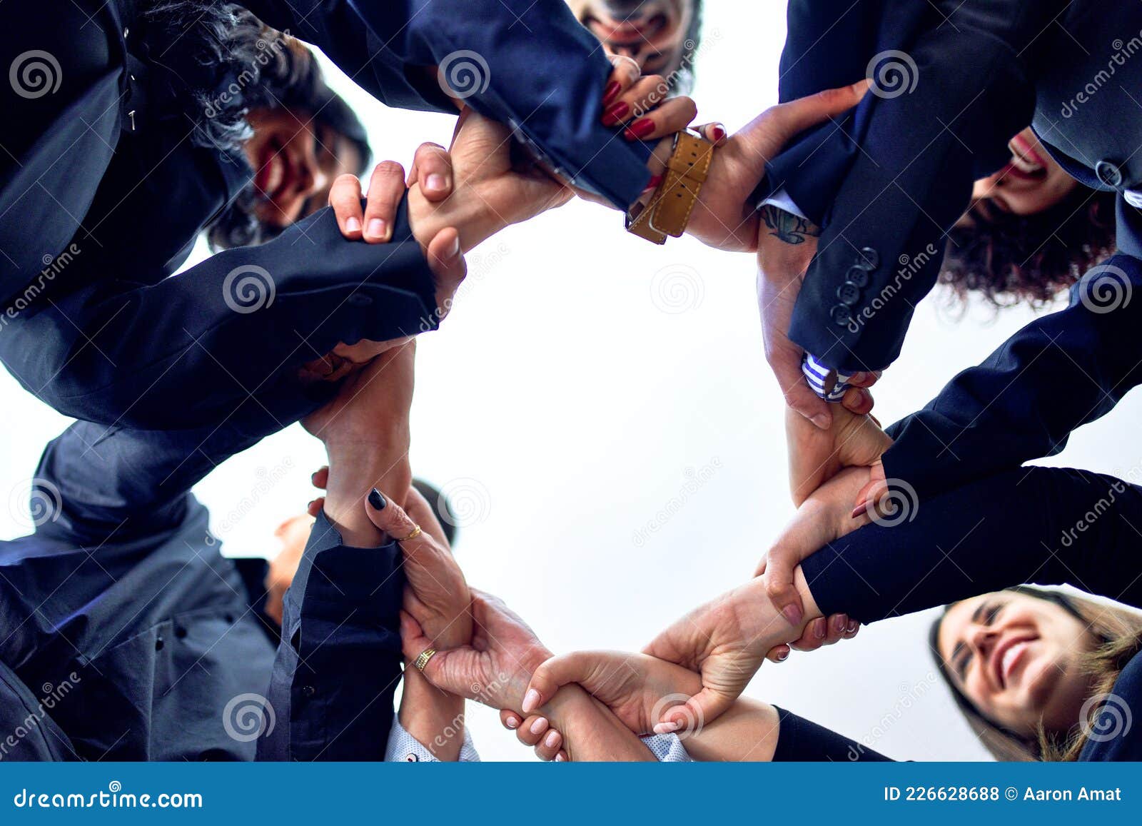Group of Business Workers Standing with Hands Together at the Office ...