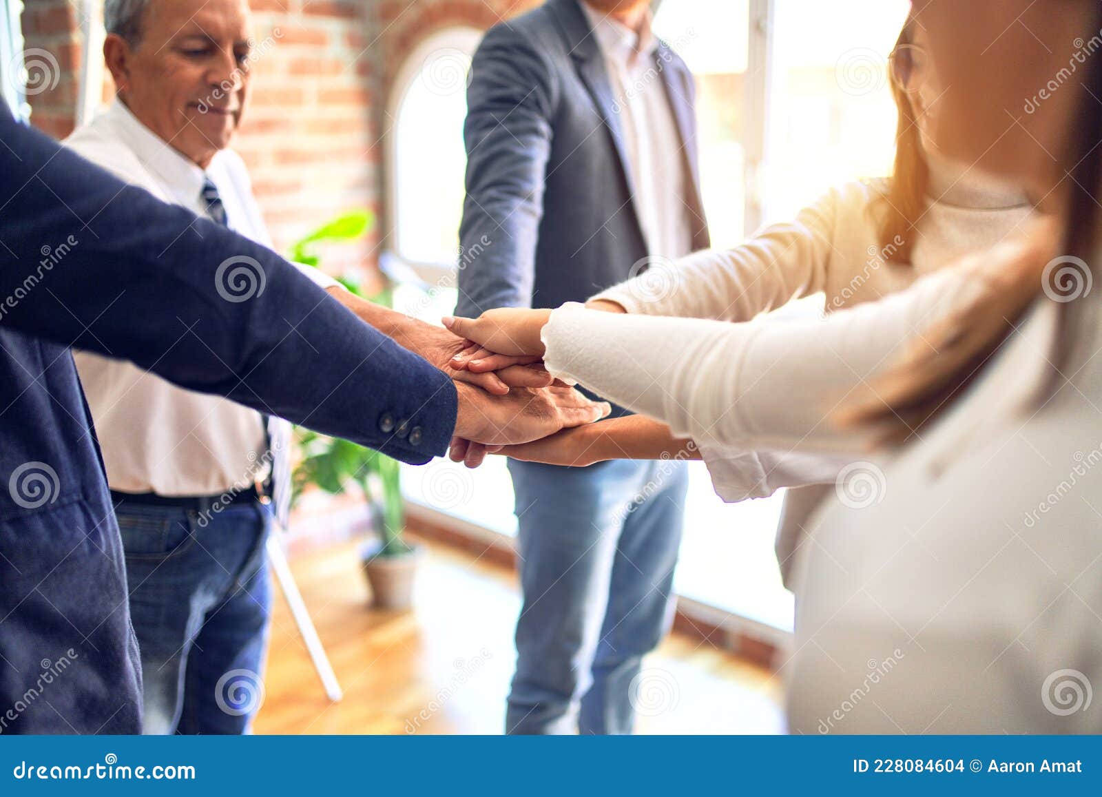 Group of Business Workers Standing with Hands Together at the Office ...