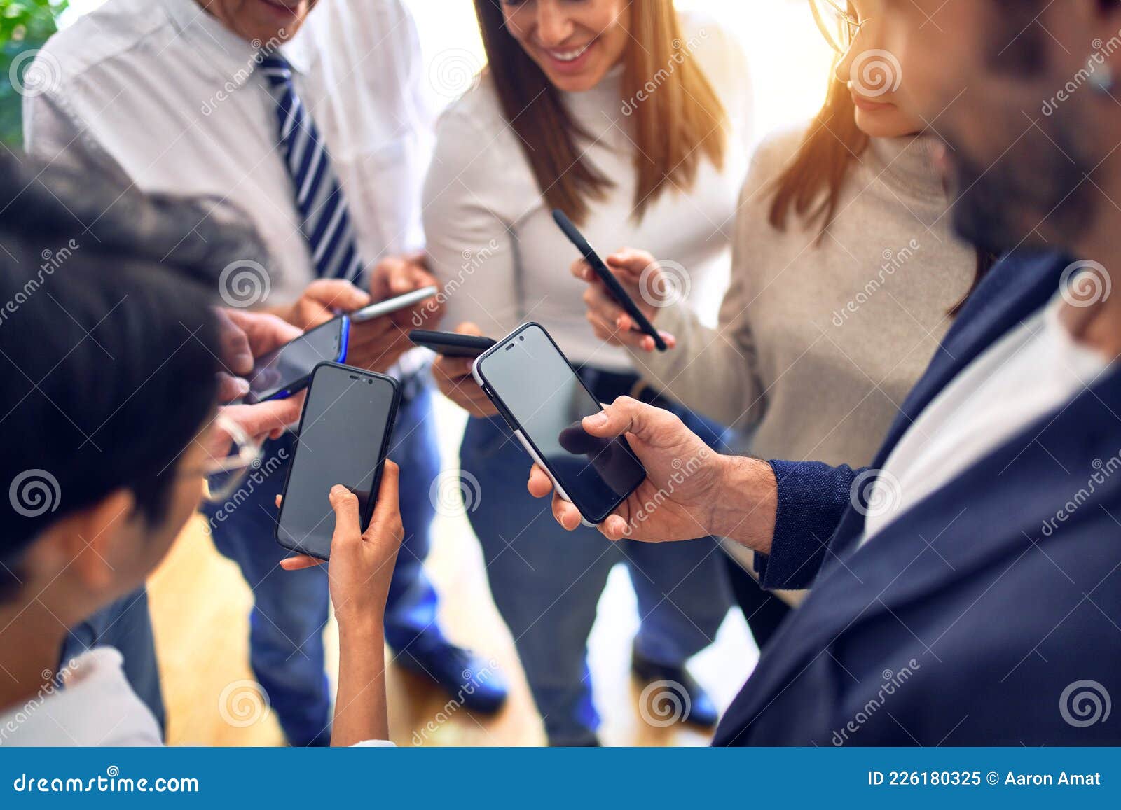 Group of Business Workers Standing with Hands Together Using Smartphone ...