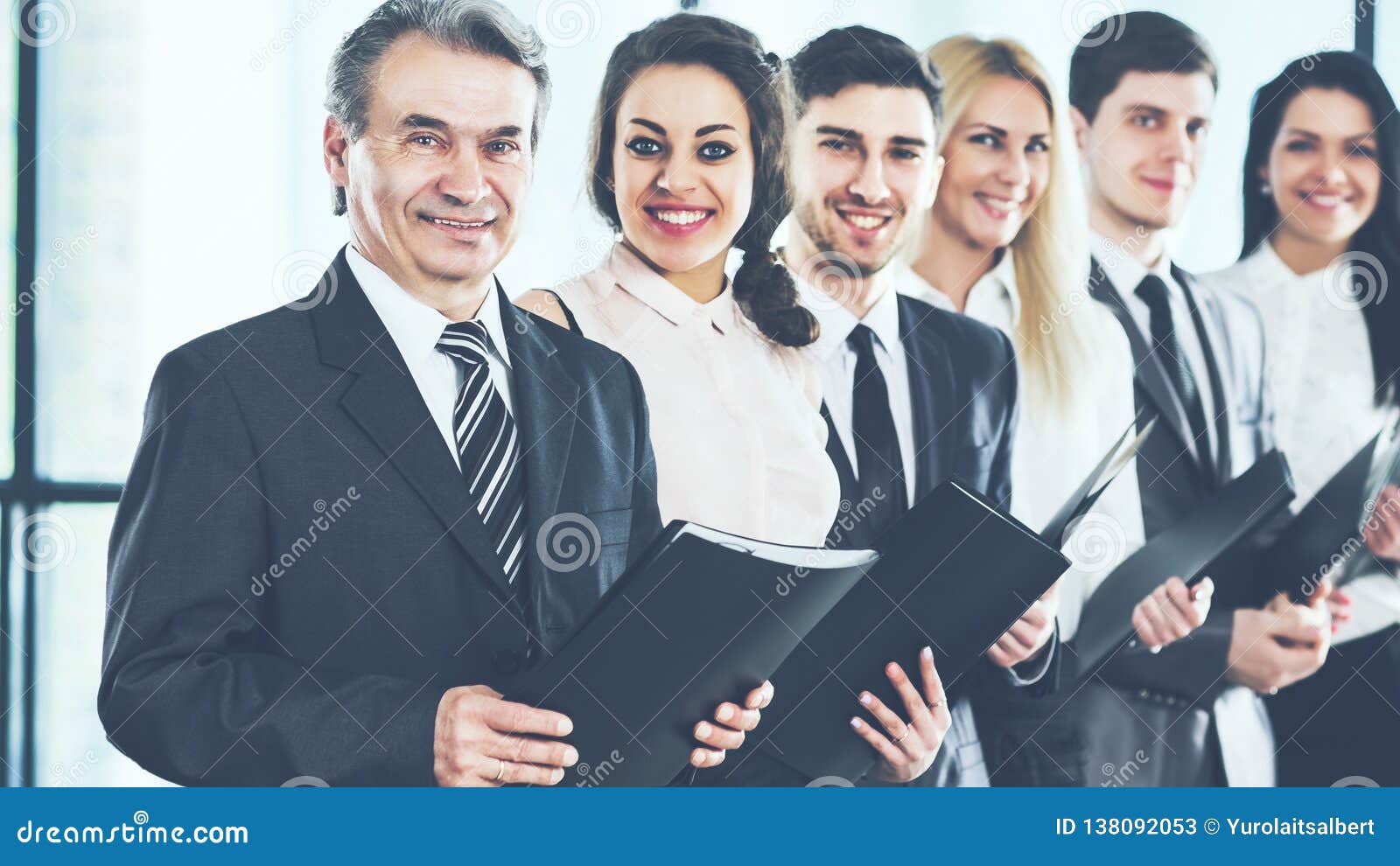 A Group of Businessmen Standing One after Another with Folders in Their ...