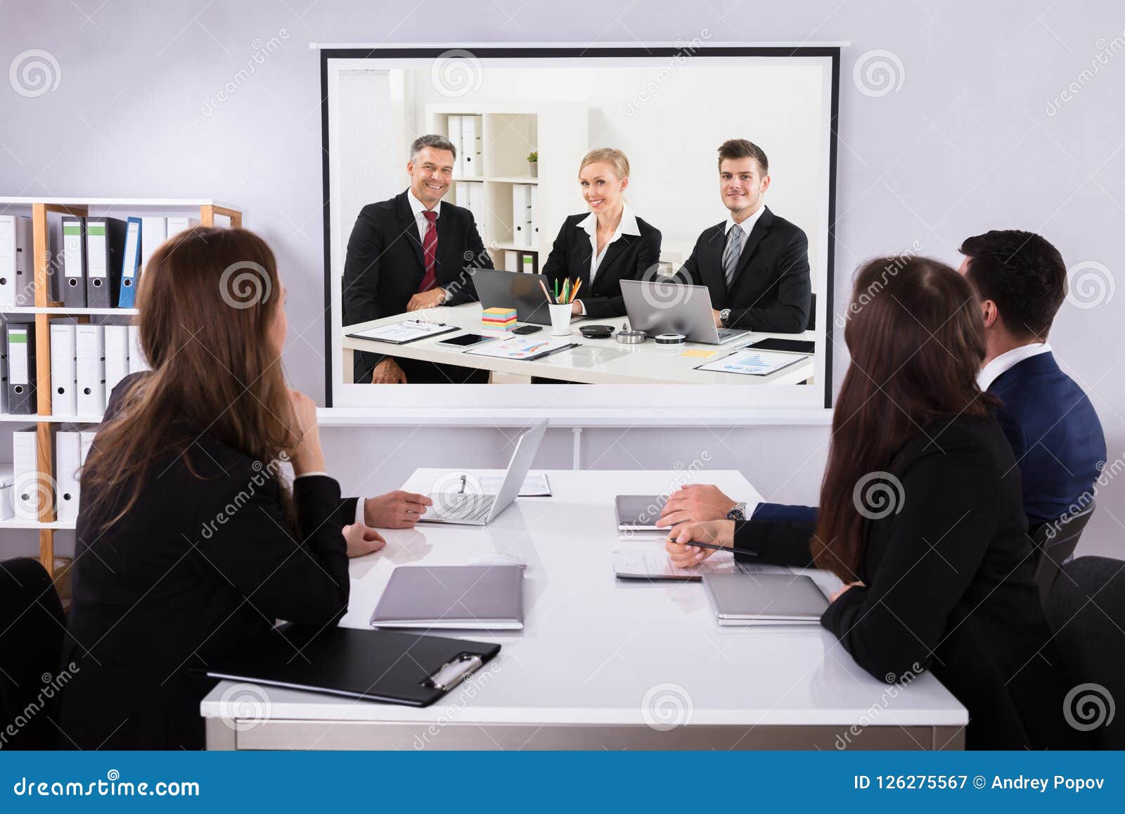 Group of Businesspeople Looking at Projector Stock Image - Image of ...