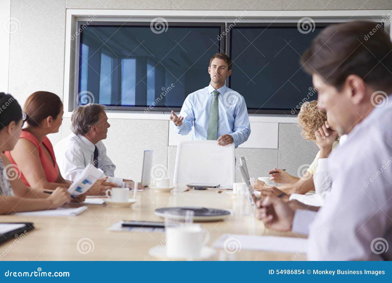 Group of Businesspeople Meeting Around Boardroom Table Stock Photo ...