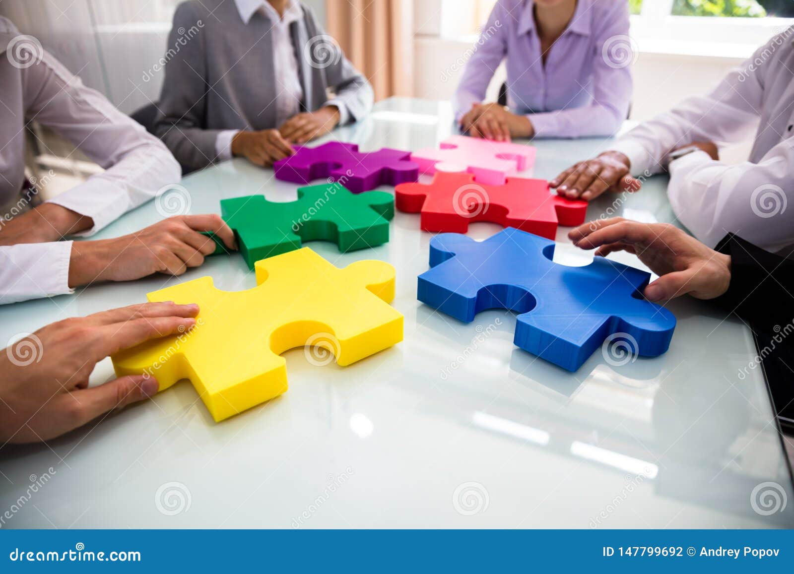 Group of Businesspeople Solving Jigsaw Puzzle Stock Photo - Image of ...