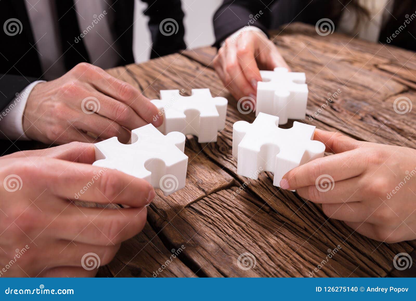 Group of Businesspeople Solving Jigsaw Puzzle Stock Photo - Image of ...
