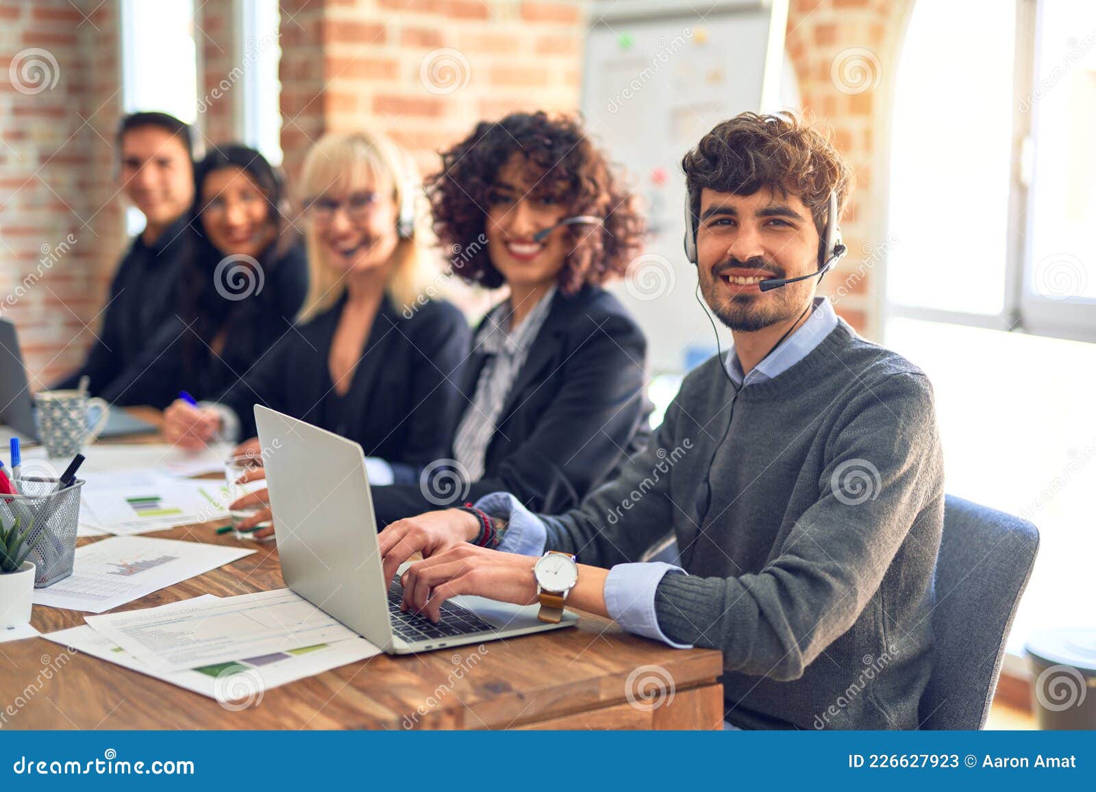 Group of Call Center Workers Working Together with Smile on Face Using ...
