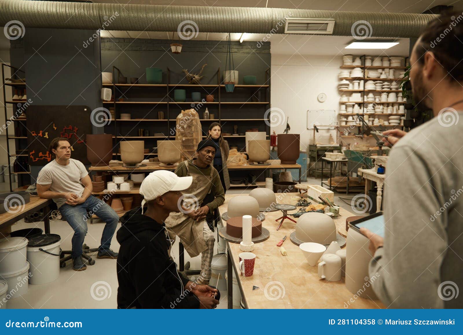 Group of Ceramic Studio Workers Having a Meeting Together Stock Photo ...