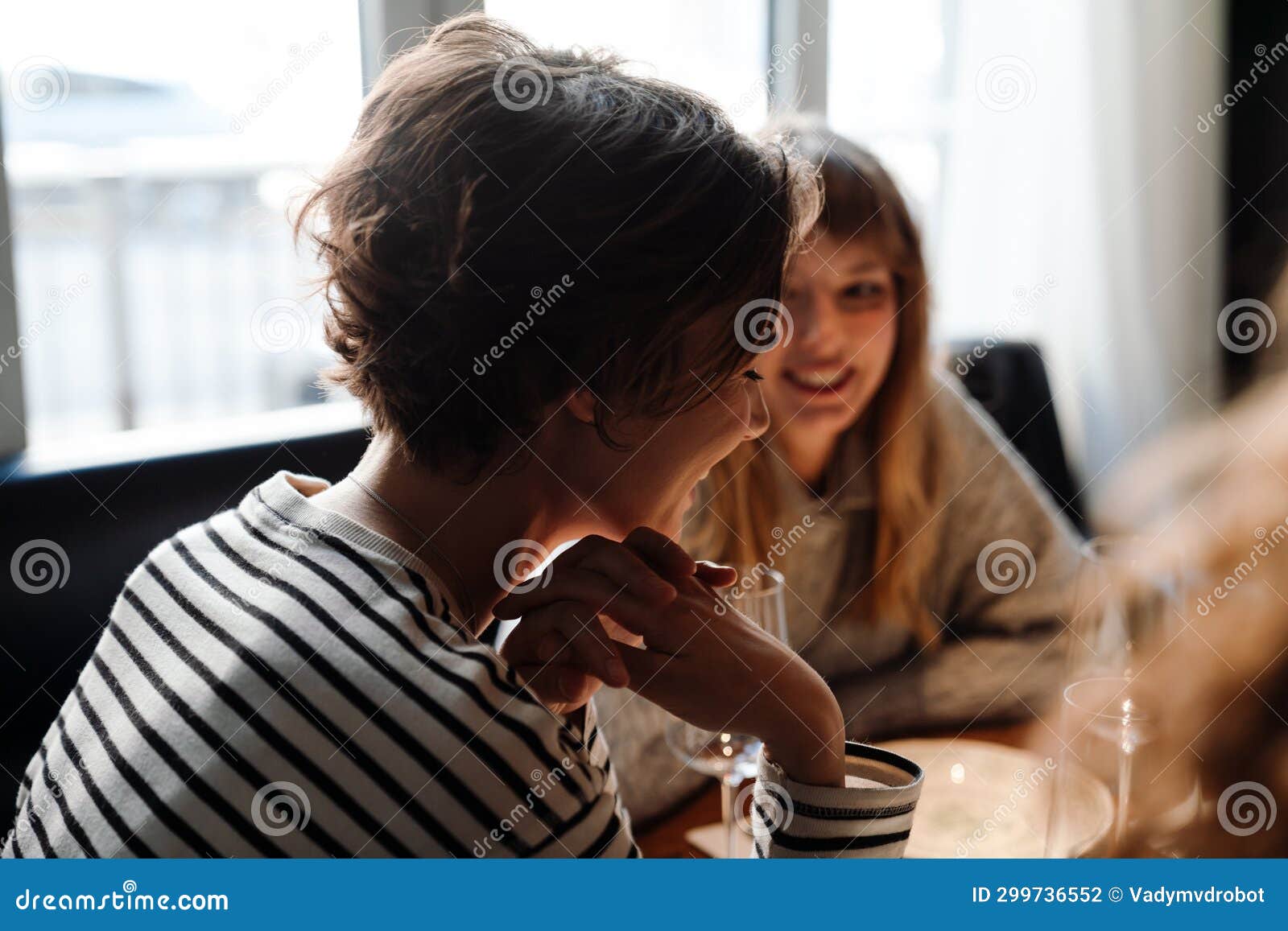 Group of Cheerful Friends Talking while Dining in Restaurant Stock ...
