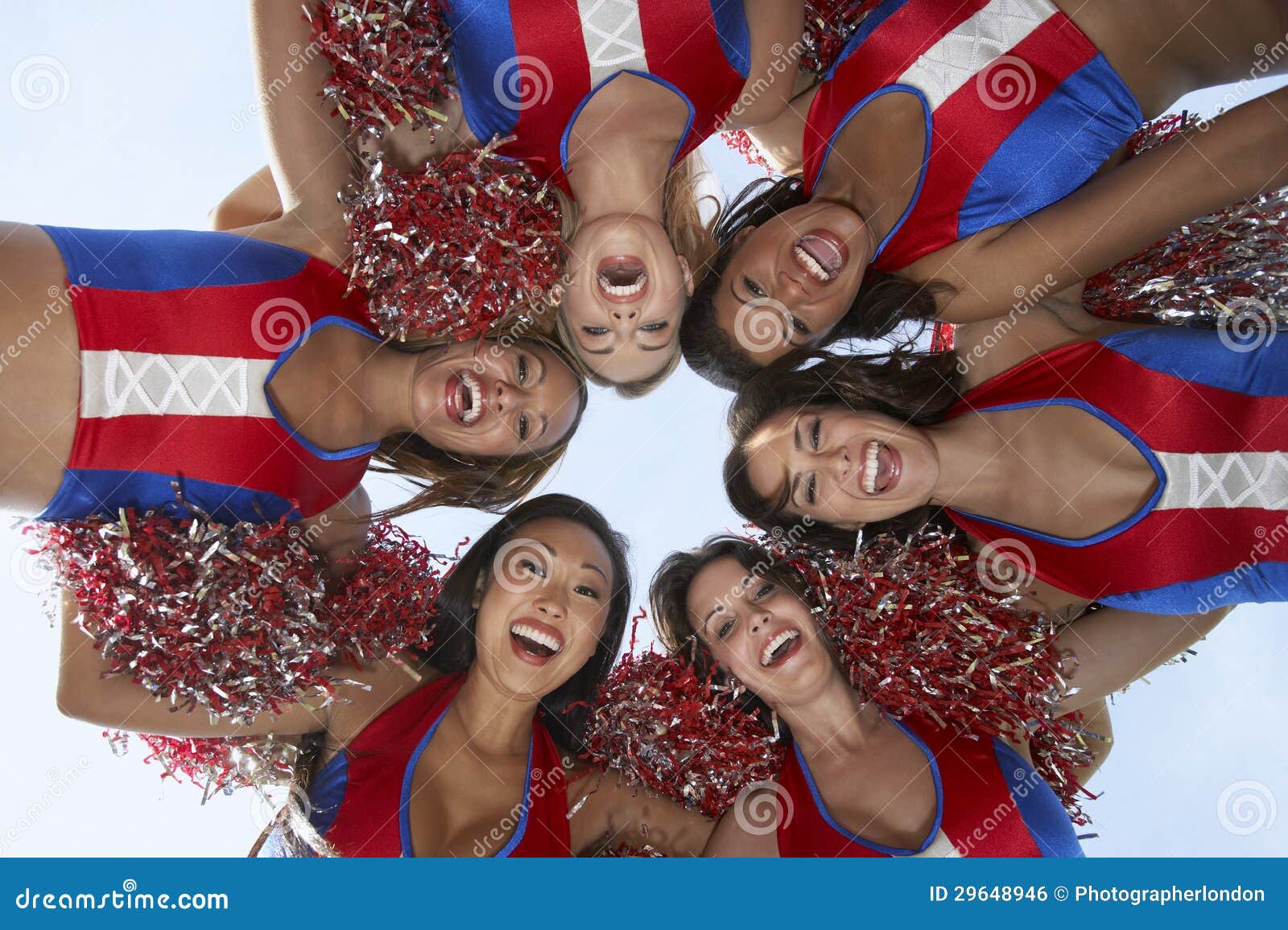 Group of Cheerleaders Forming a Huddle Stock Photo - Image of looking ...