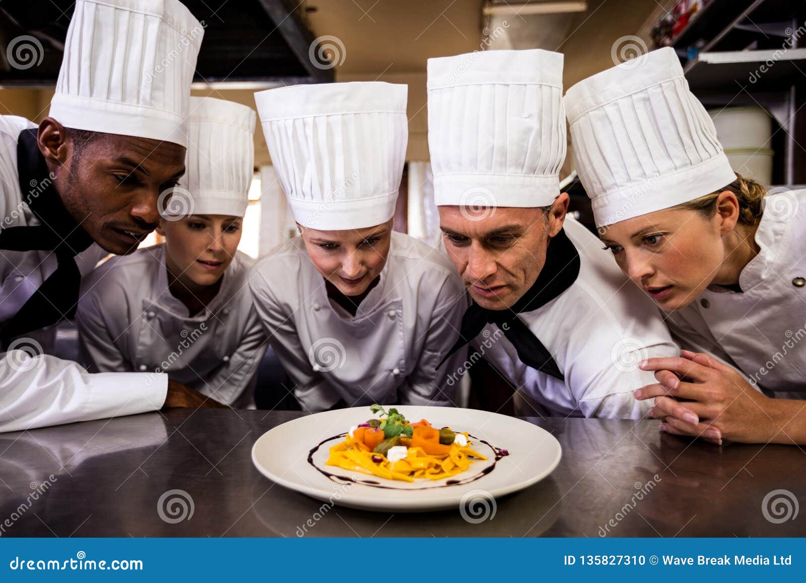 Group of Chefs Looking at Prepared Pasta in Kitchen Stock Photo - Image ...