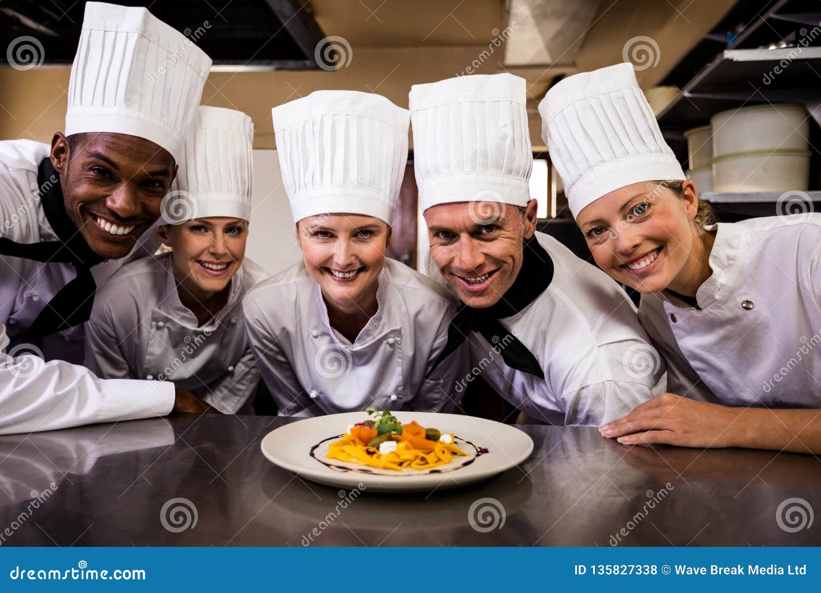 Group of Chefs Looking at Prepared Pasta in Kitchen Stock Photo - Image ...