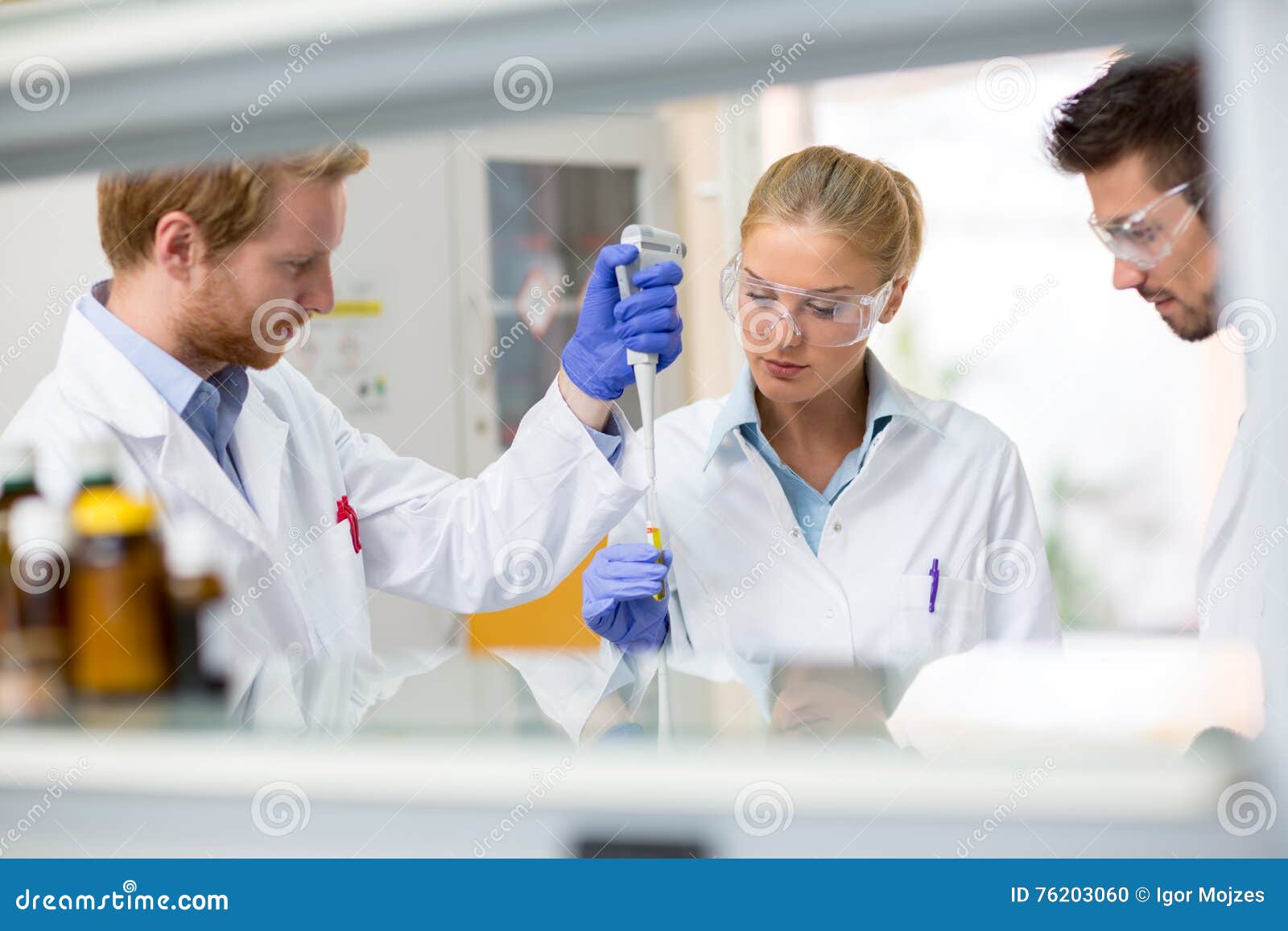 Group of Chemical Scientists Place Sample of Fluid in Test Pipet Stock ...