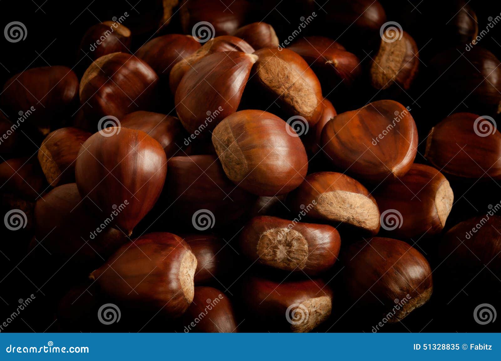 Group of Chestnuts Illuminated by a Light Side. Dark Background. Stock ...