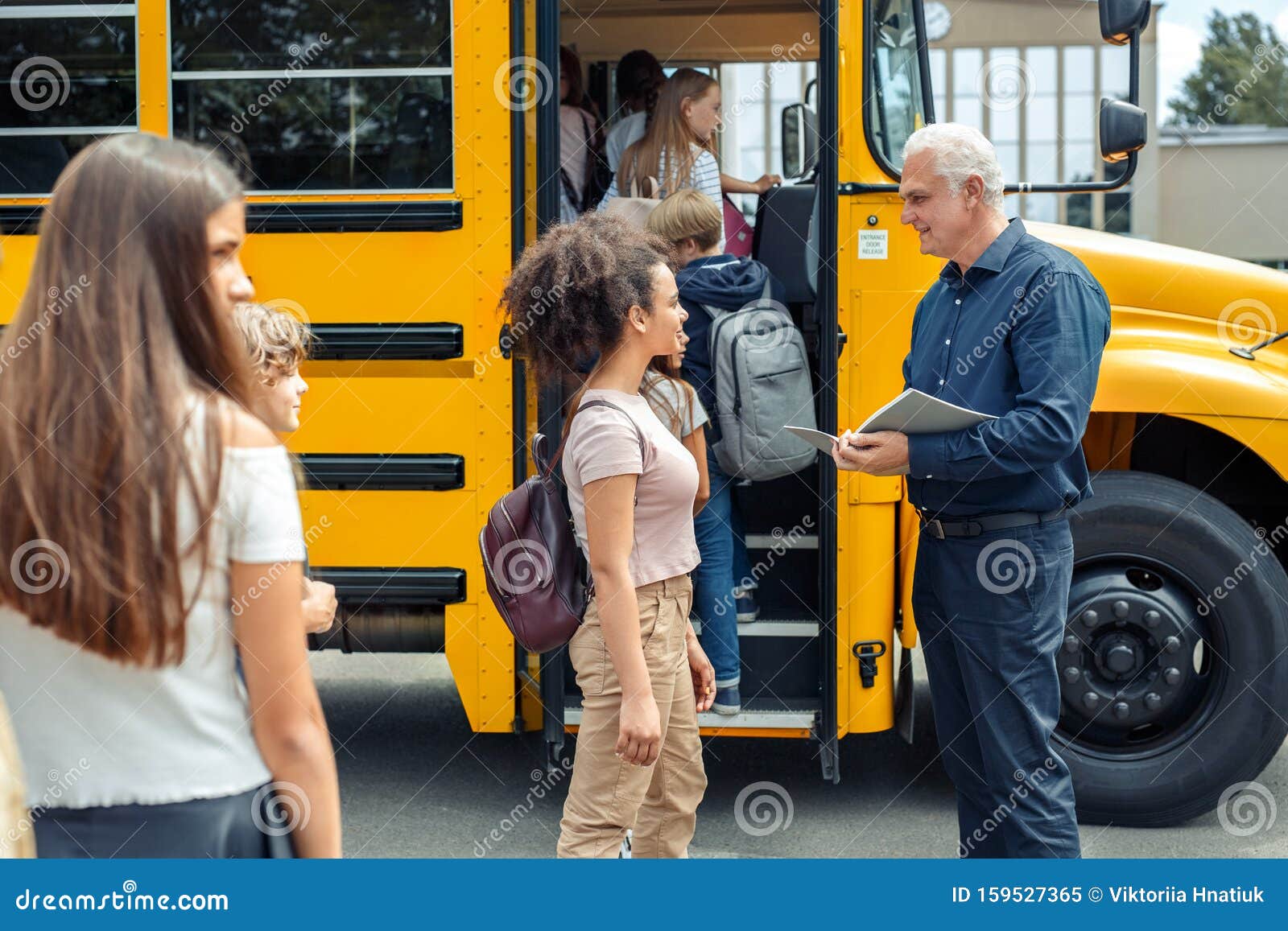 Classmates Going into School Bus while Driver Checking Attendance ...