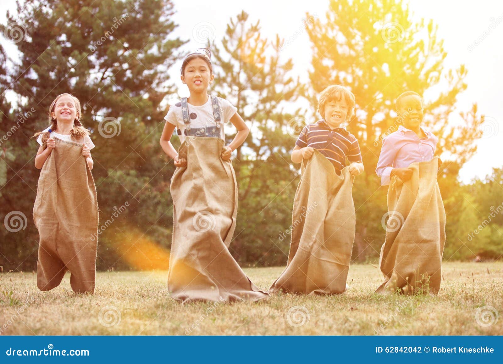 Group of Children Competing at Sack Race Stock Photo - Image of nature ...
