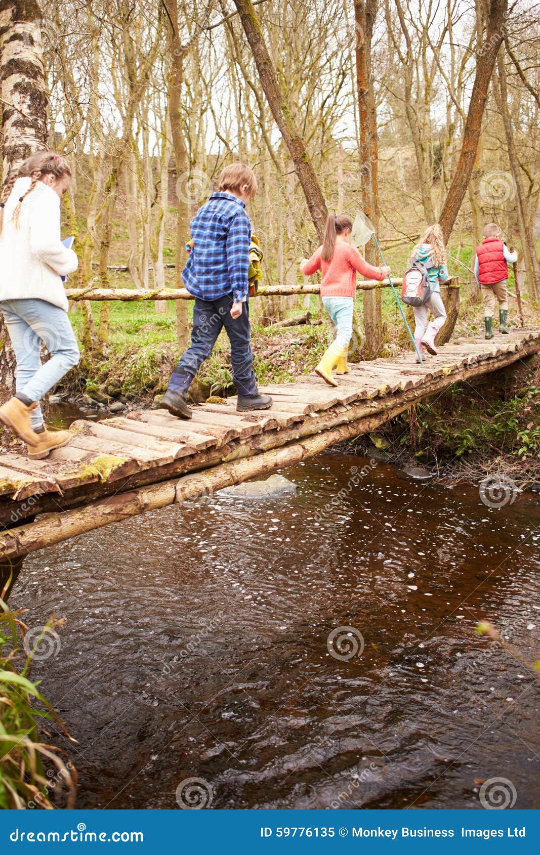Group of Children Crossing Stream on Wooden Bridge Stock Image - Image ...