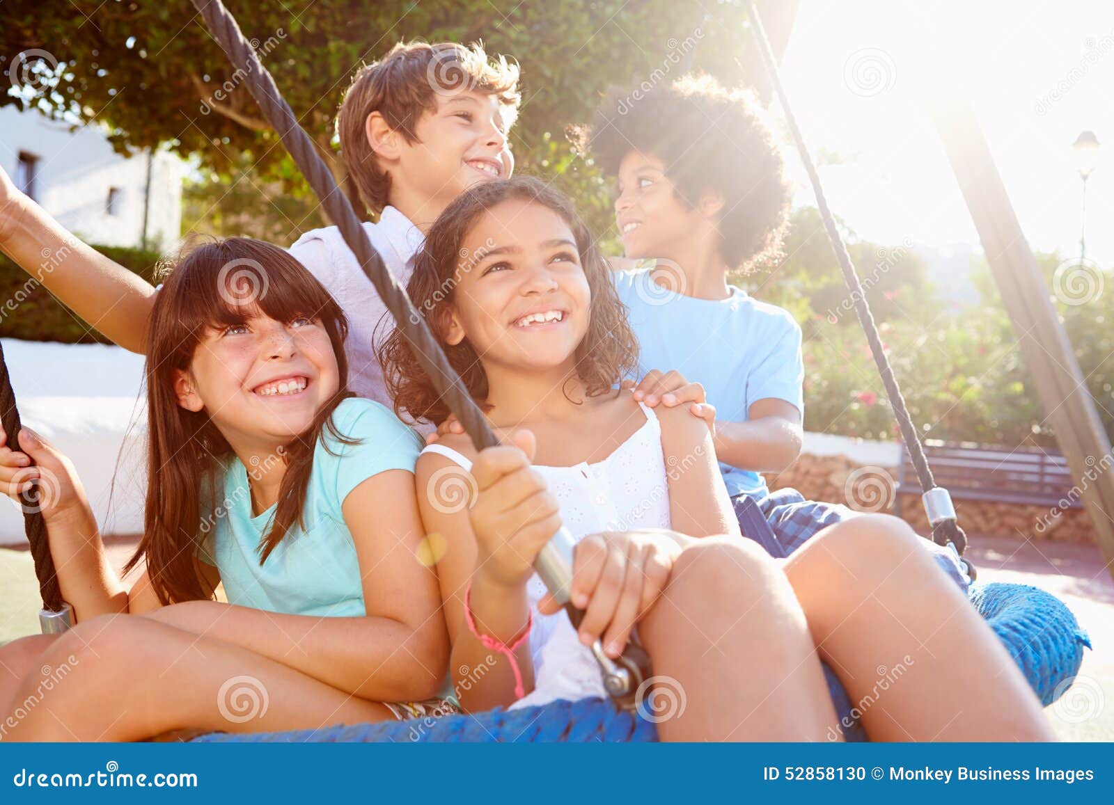 Group of Children Having Fun on Swing in Playground Stock Photo - Image ...