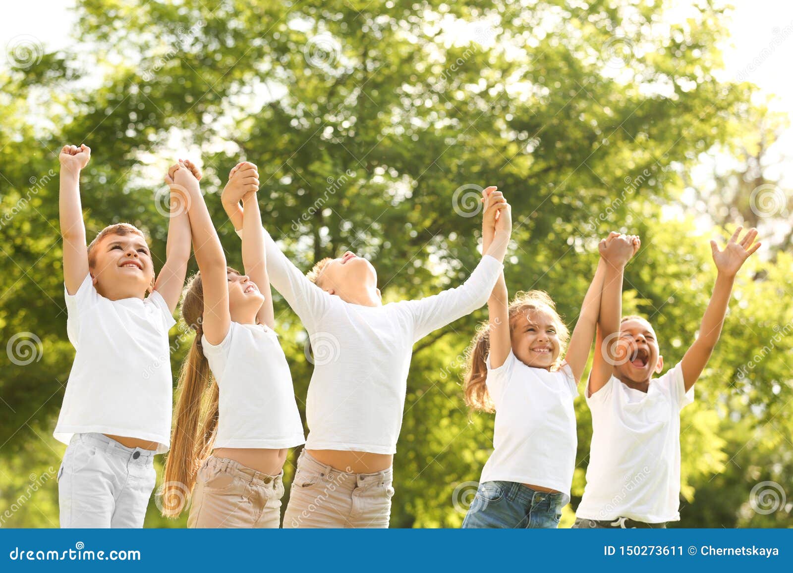Group of Children Holding Hands Up in Park Stock Image - Image of ...